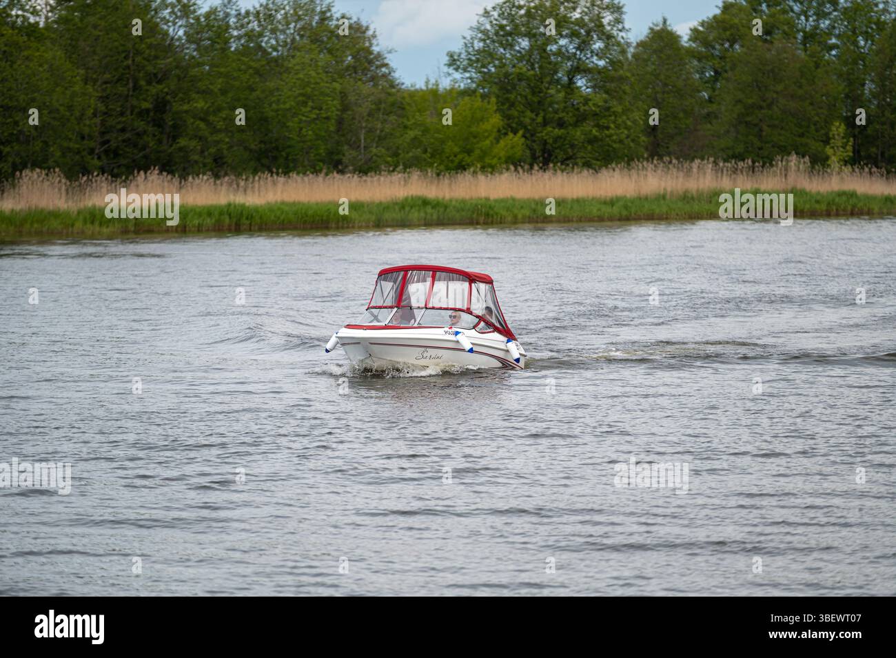 Delta of the Nemuna River, Lithuania - May 24, 2025: A boat glides ...