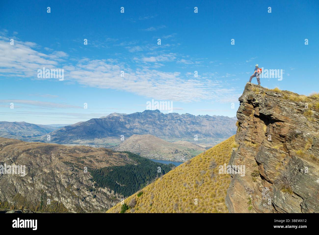 A walker standing on a sheer cliff edge along Jan's Peak overlooking ...