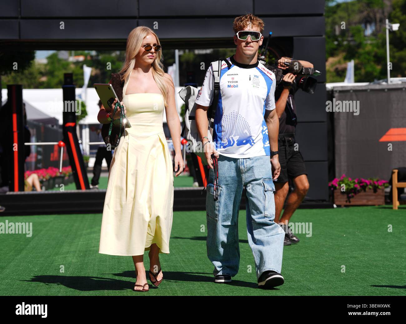 Racing Bulls' Liam Lawson and Hannah St. John arrive at the Circuit de ...
