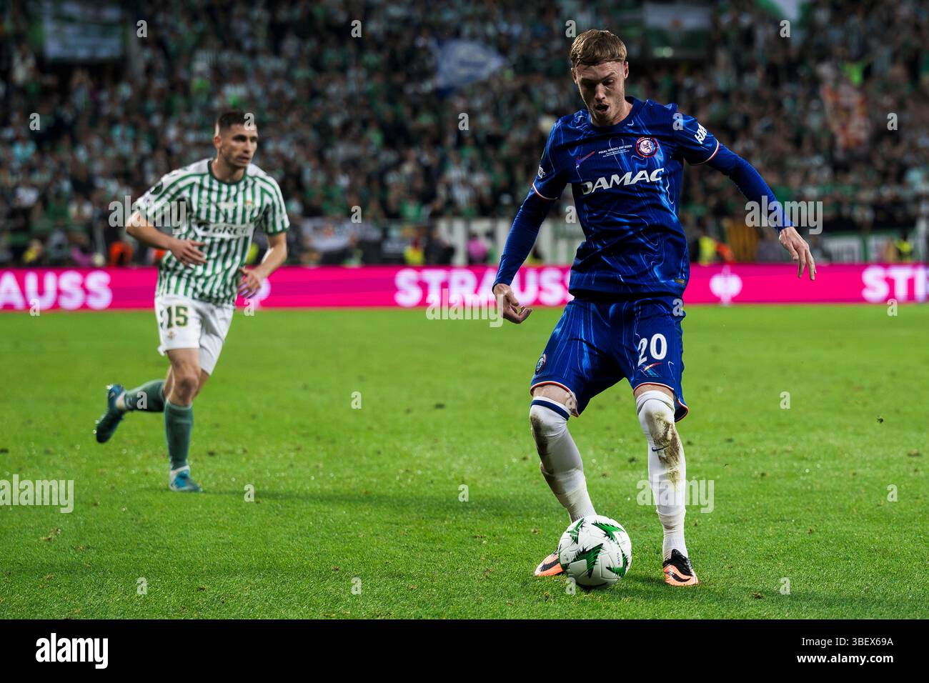 Cole Palmer of Chelsea FC is challenged by Romain Perraud of Ream Betis ...