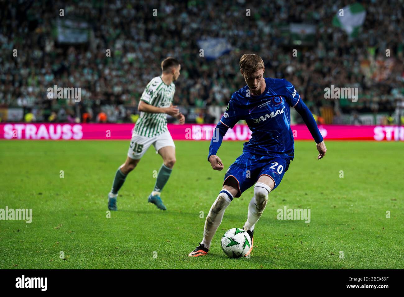Cole Palmer of Chelsea FC is challenged by Romain Perraud of Ream Betis ...