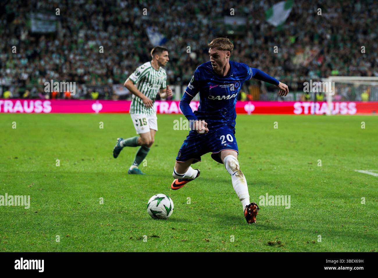 Cole Palmer of Chelsea FC is challenged by Romain Perraud of Ream Betis ...