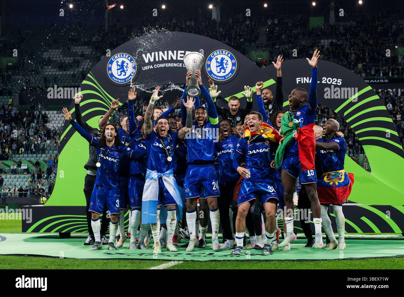 Reece James of Chelsea FC lifts the trophy as teammates celebrate ...