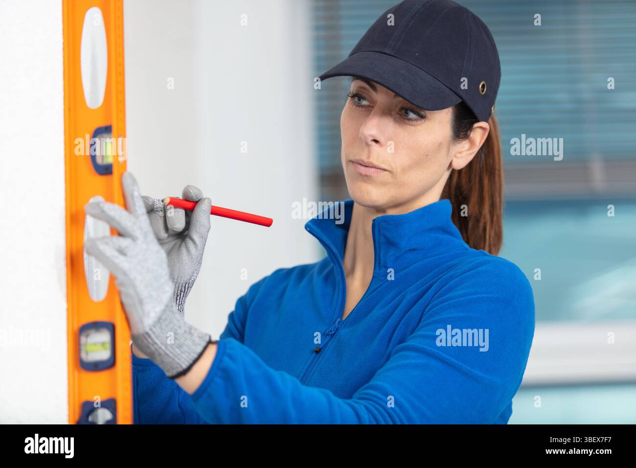 attractive young female construction worker with spirit level Stock ...