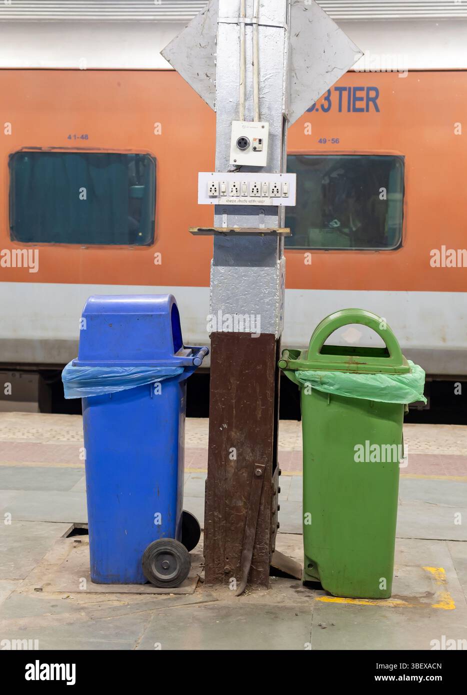 wet and dry dustbin kept at railway station with standing train ...