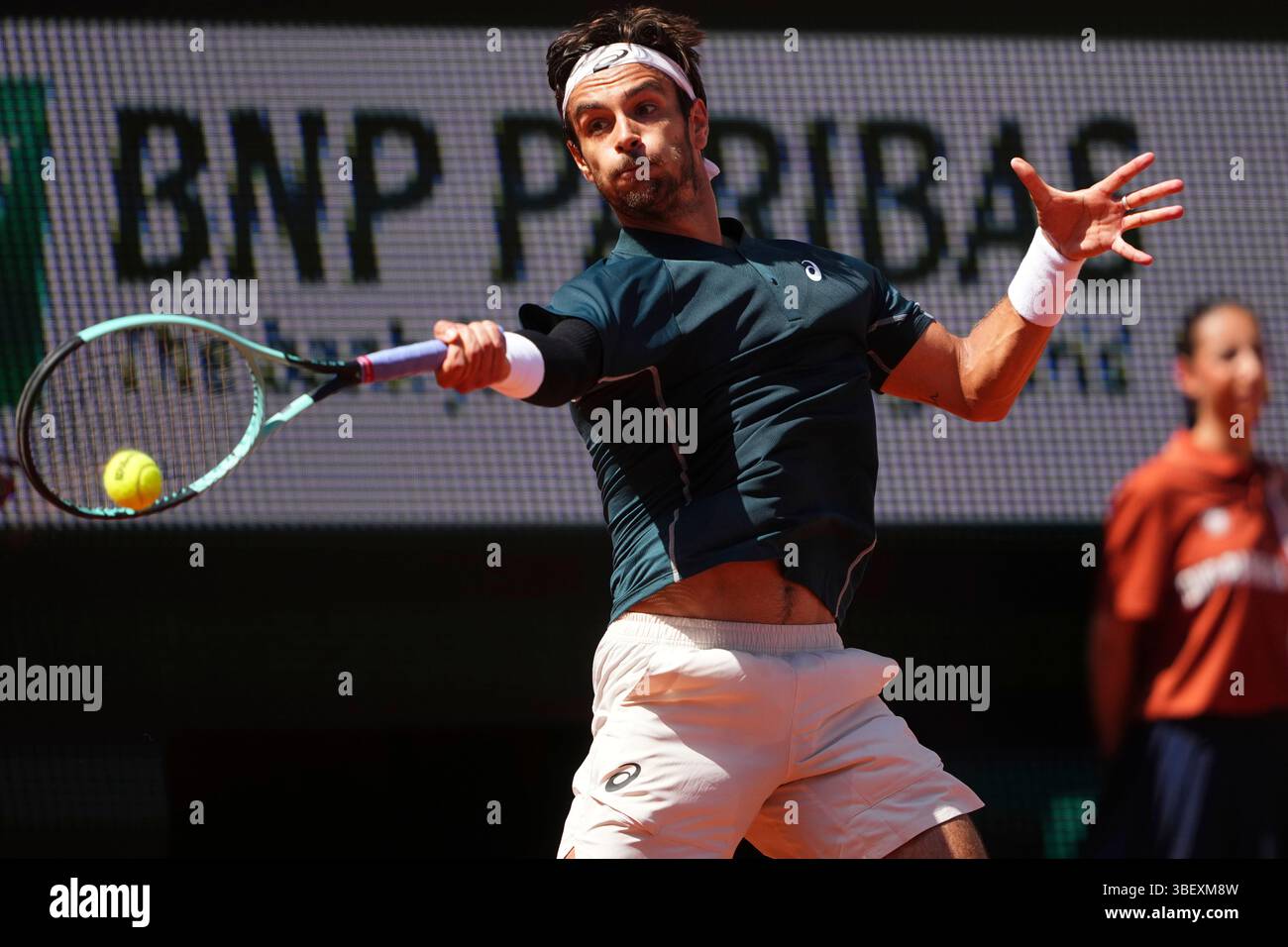 Italy's Lorenzo Musetti returns the ball to Argentina's Mariano Navone ...