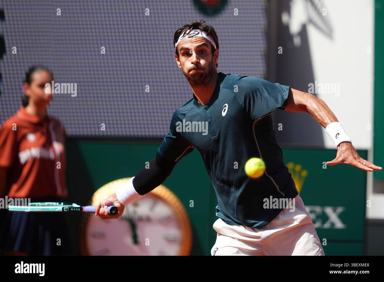 Italy's Lorenzo Musetti returns the ball to Argentina's Mariano Navone ...
