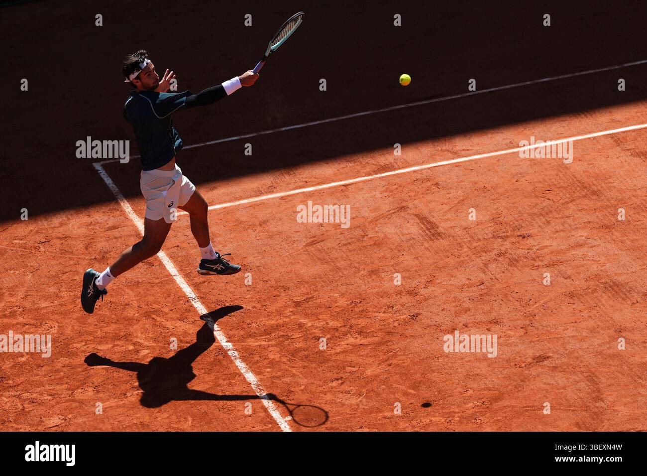 Italy's Lorenzo Musetti returns the ball to Argentina's Mariano Navone ...