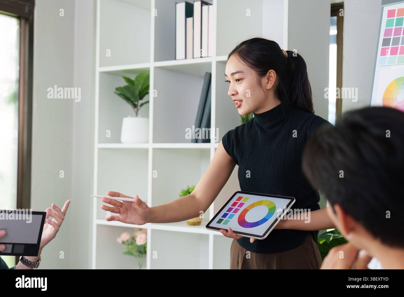 Presenting UX UI Concepts. A designer showcasing a digital design to the team Stock Photo - Alamy