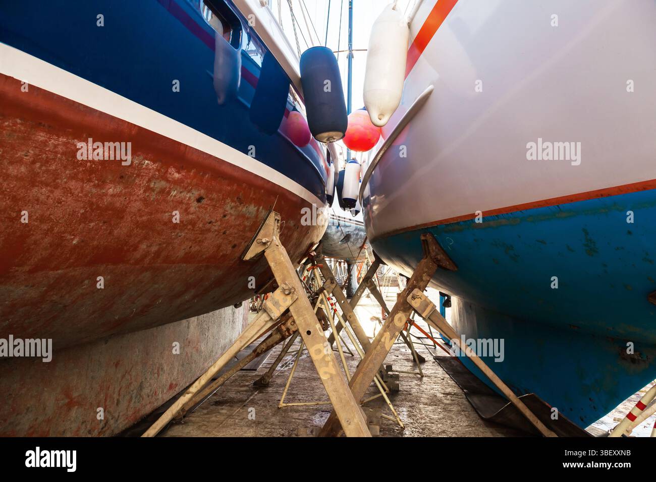 Sailing yachts are in dry dock and supported by metal supports Stock ...