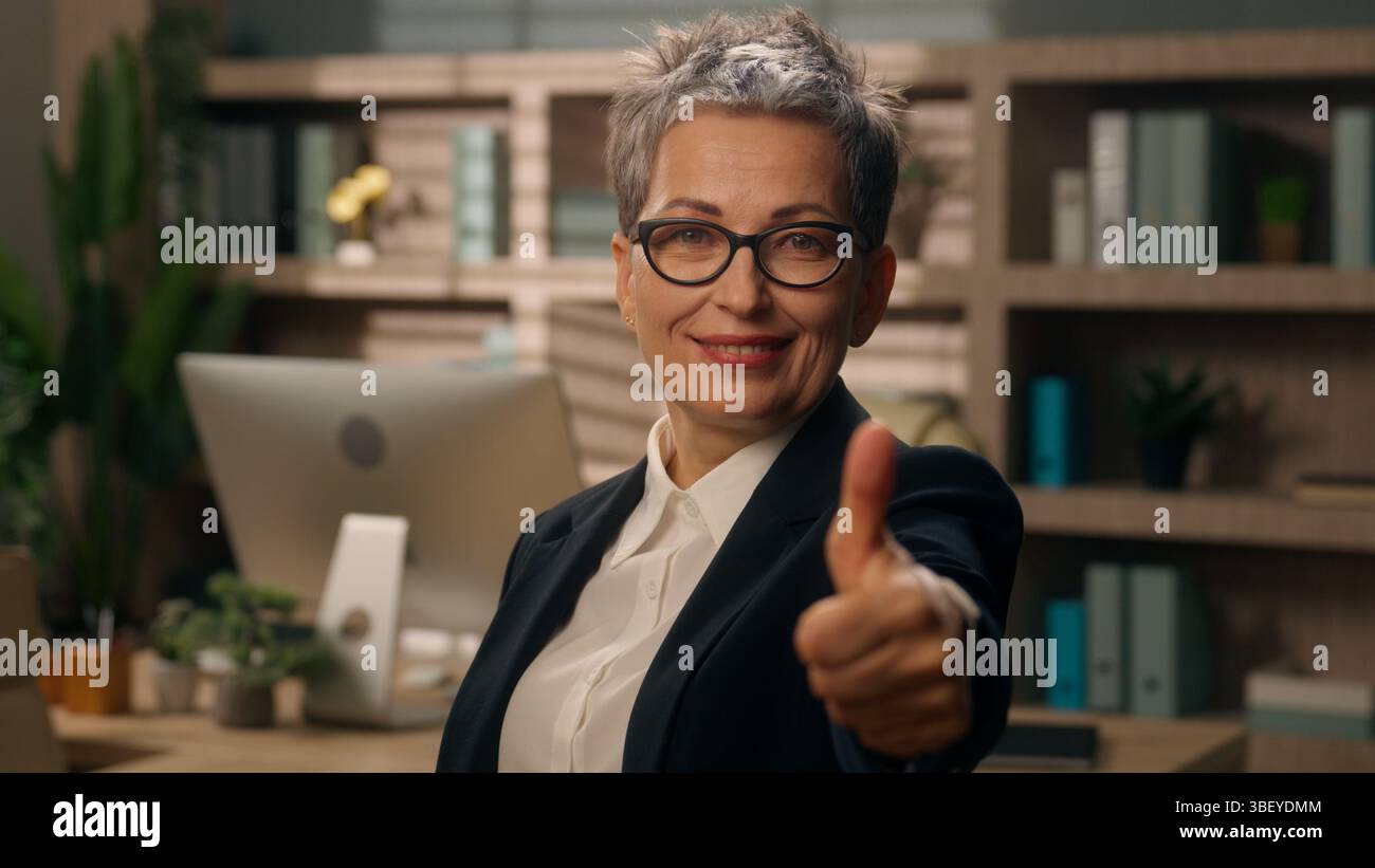 Caucasian smiling old business woman pointing hey you looking at camera ...