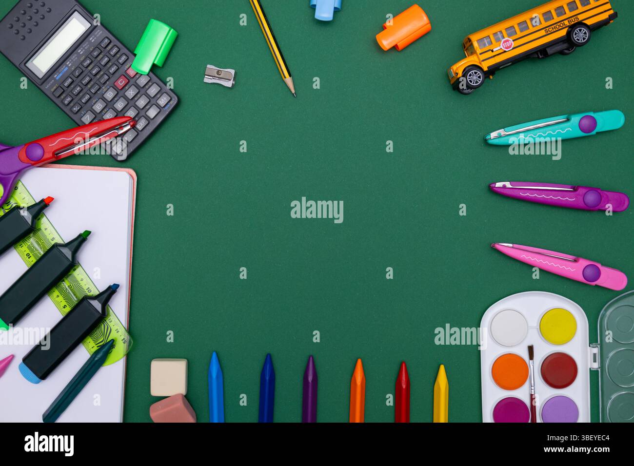 Overhead view of colorful school supplies including crayons, scissors ...