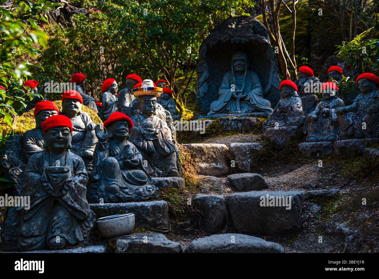 Small stone statues with red hats in Daishoin Temple on Miyajima ...