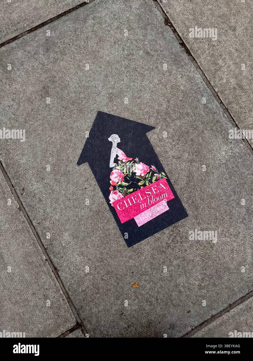 A directional arrow on a street path in Chelsea, London, England ...