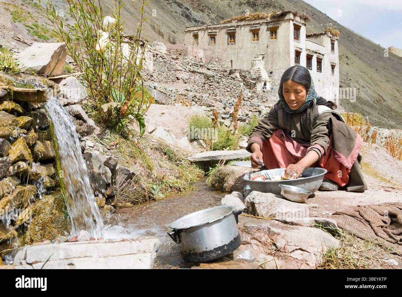 Woman doing the washing-up, Yurutse valley, Hemis National Park, Ladakh ...