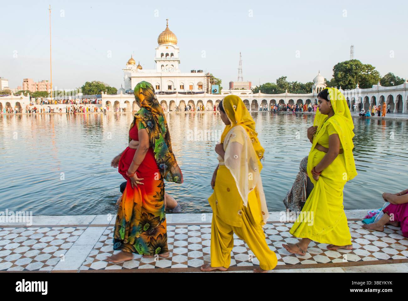 Followers by the 'Sarovar' pond whose water is considered holy, inside ...