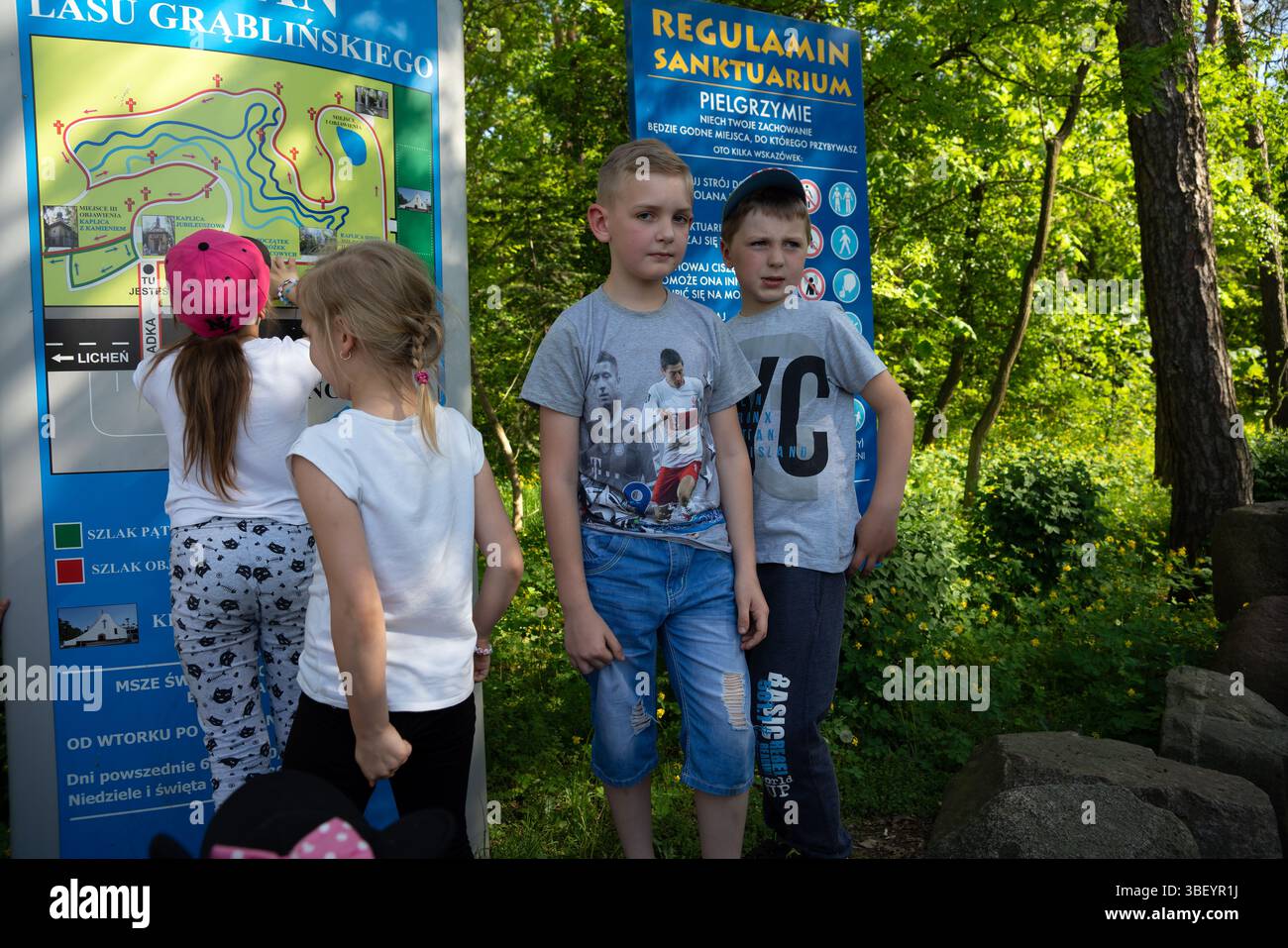 Licheń, Greater Poland; a group of children on a trip in the forest, in ...