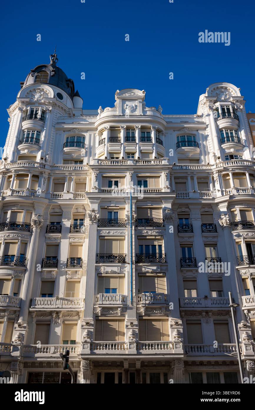 Looking up at ornate buildings in the famous Gran Via, the main ...