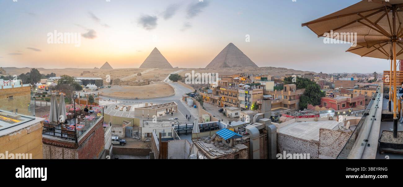 View of Giza Pyramids from rooftop terrace at sunset, Cairo, Egypt ...