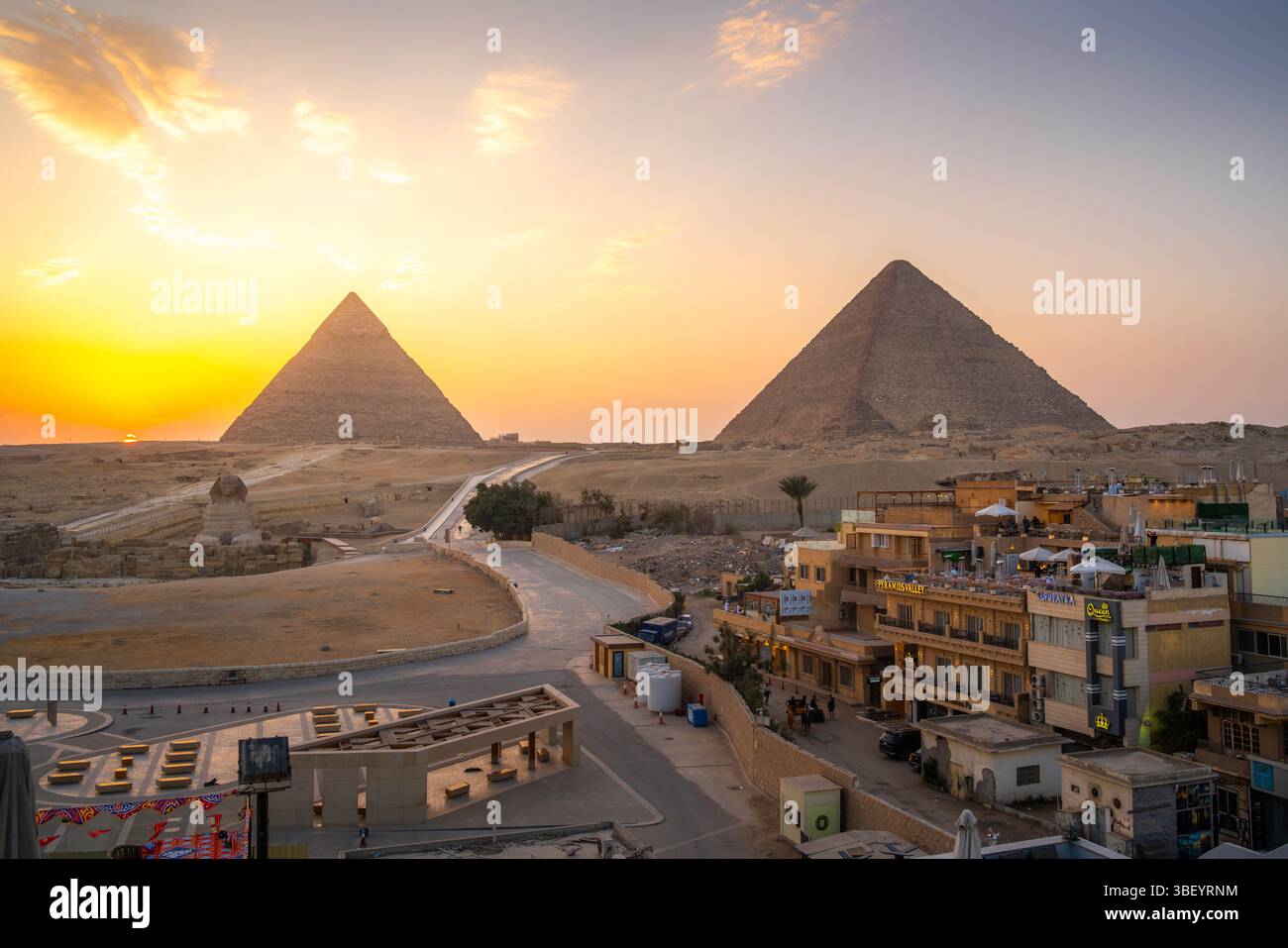 View of Giza Pyramids from rooftop terrace at sunset, Cairo, Egypt ...