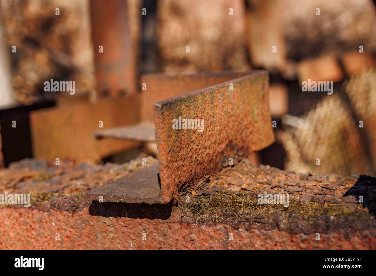 Close-up of rusted and weathered steel beams in an outdoor scrapyard or ...