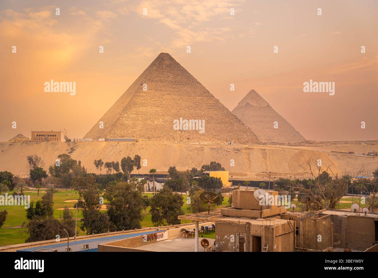 View of the Giza Pyramids from rooftop terrace during golden hour, Giza ...