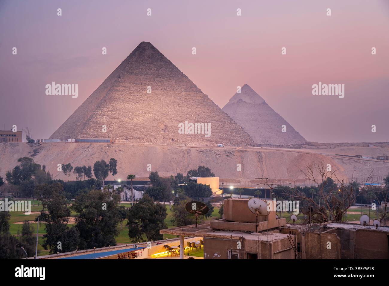 View of the Giza Pyramids from rooftop terrace during golden hour, Giza ...