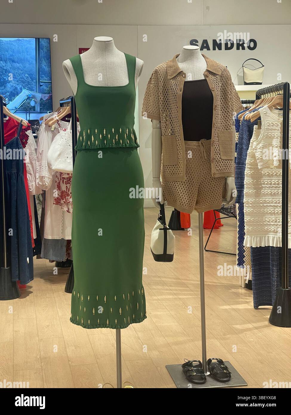 Sandro summer fashion display with green dress and crochet outfit Stock ...