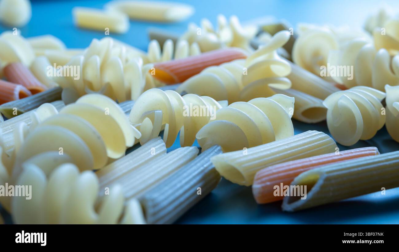 Assorted Pasta Shapes on blue background Stock Photo - Alamy