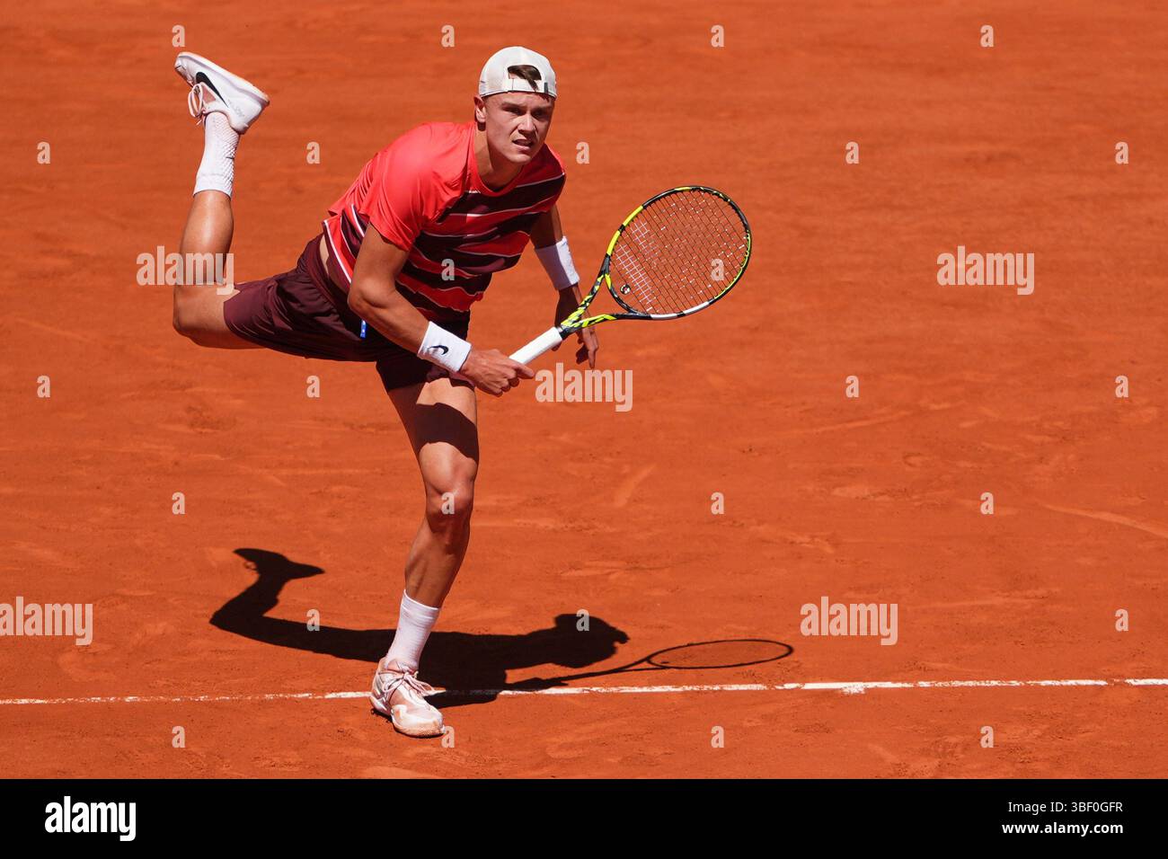 Denmark's Holger Rune serves the ball to France's Quentin Halys during ...