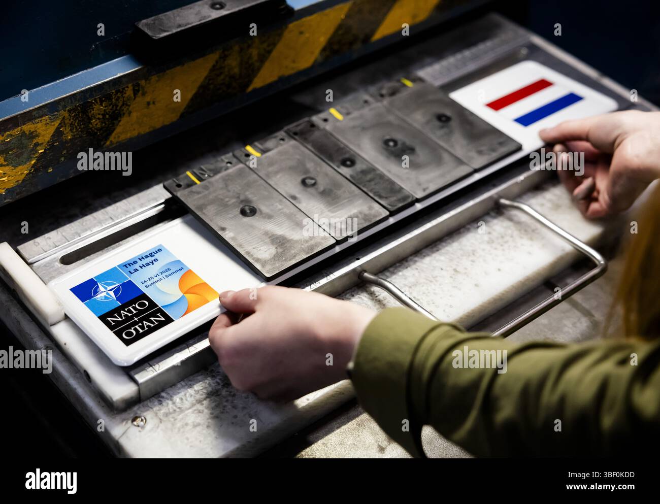 A license plate for the Netherlands' delegation is being printed ahead ...