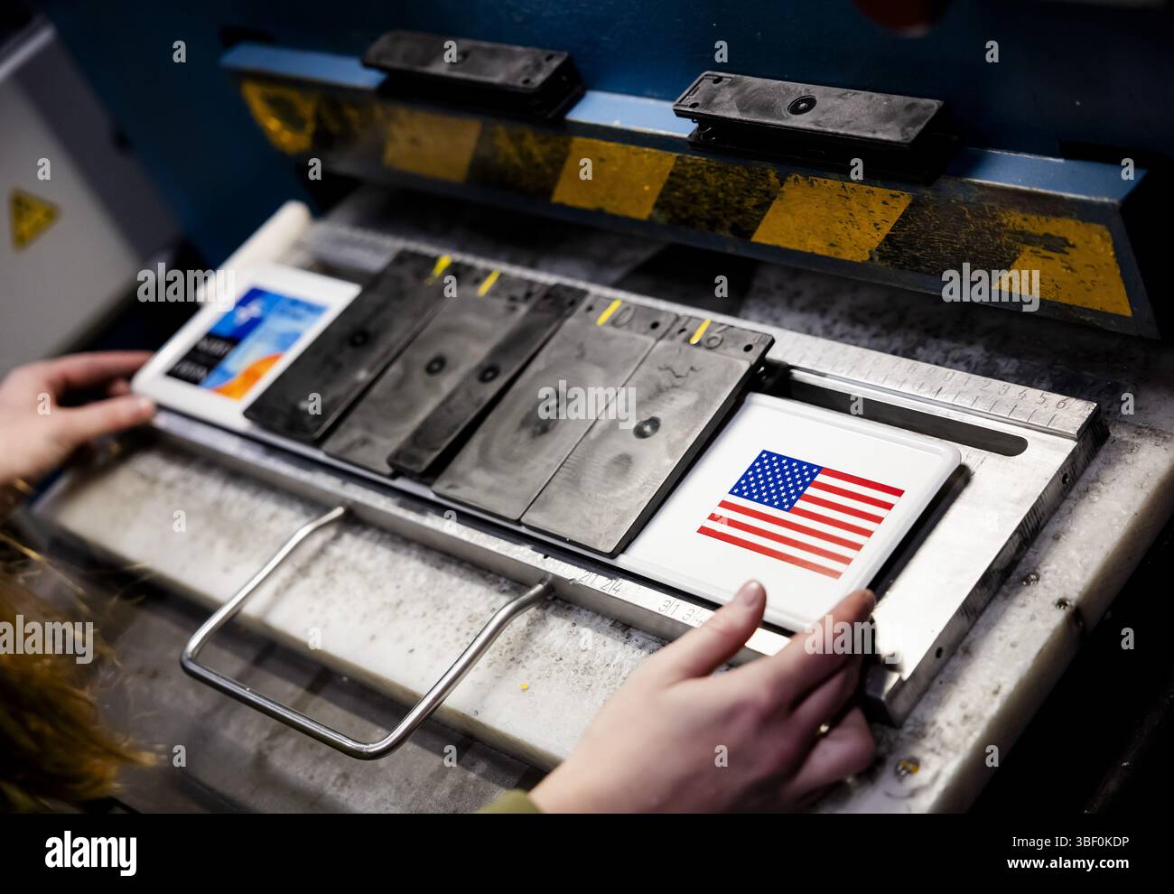 A license plate for the United States delegation is being printed ahead ...