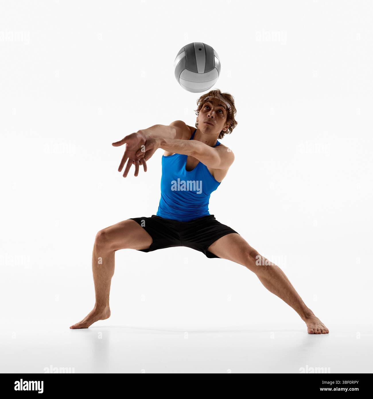 Man, volleyball player prepares for ball reception standing wide with ...