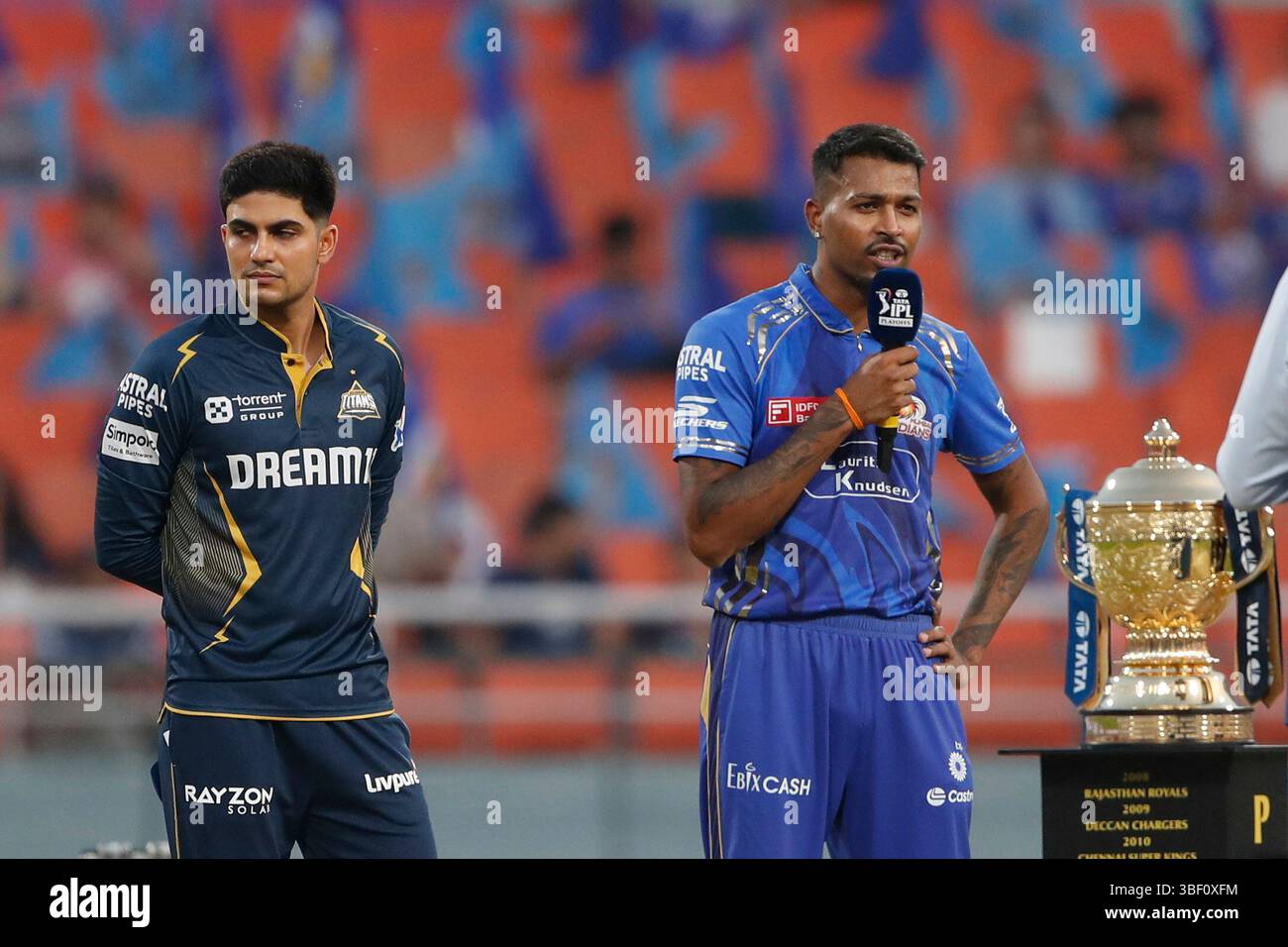 Gujarat Titans' captain Shubman Gill, left, looks away as Mumbai Indians' captain Hardik Pandya ...