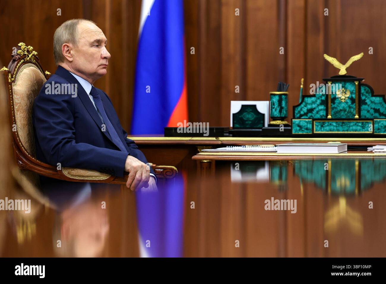 Russian President Vladimir Putin listens to Archpriest Alexander ...