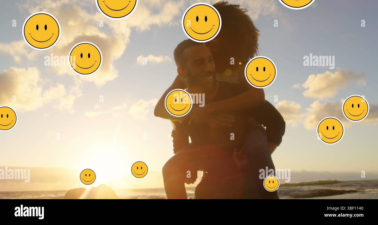 Image of emoji icons over happy african american couple embracing at ...