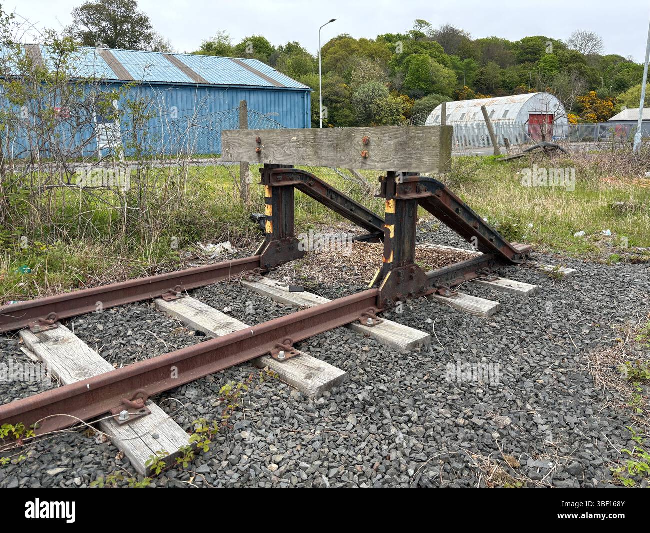 Abandoned railway buffer stops near Rosyth Castle, Scotland, blending ...