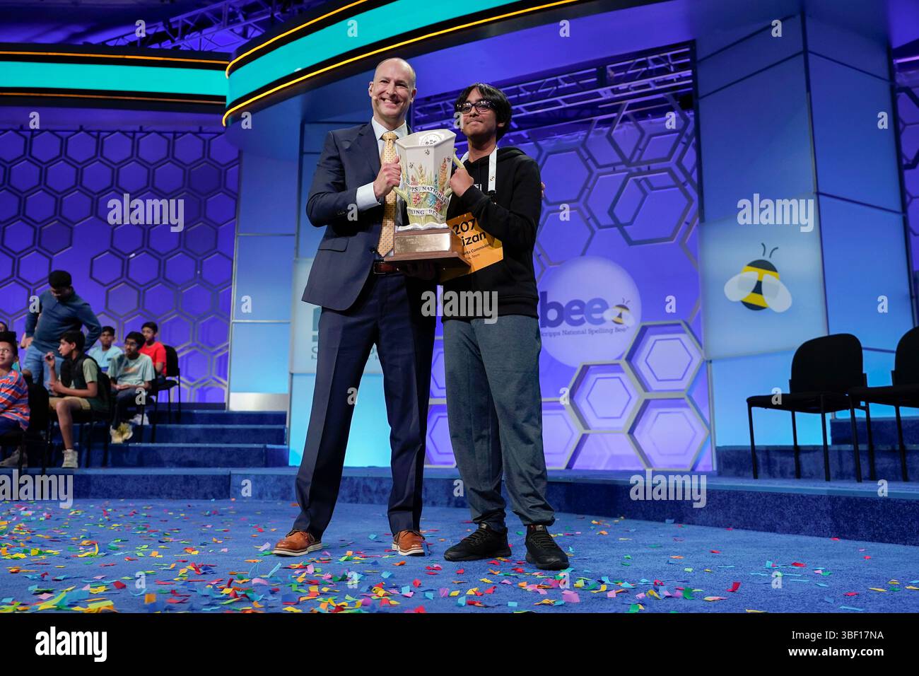 E.W. Scripps Company president and CEO Adam Symson presents the trophy ...
