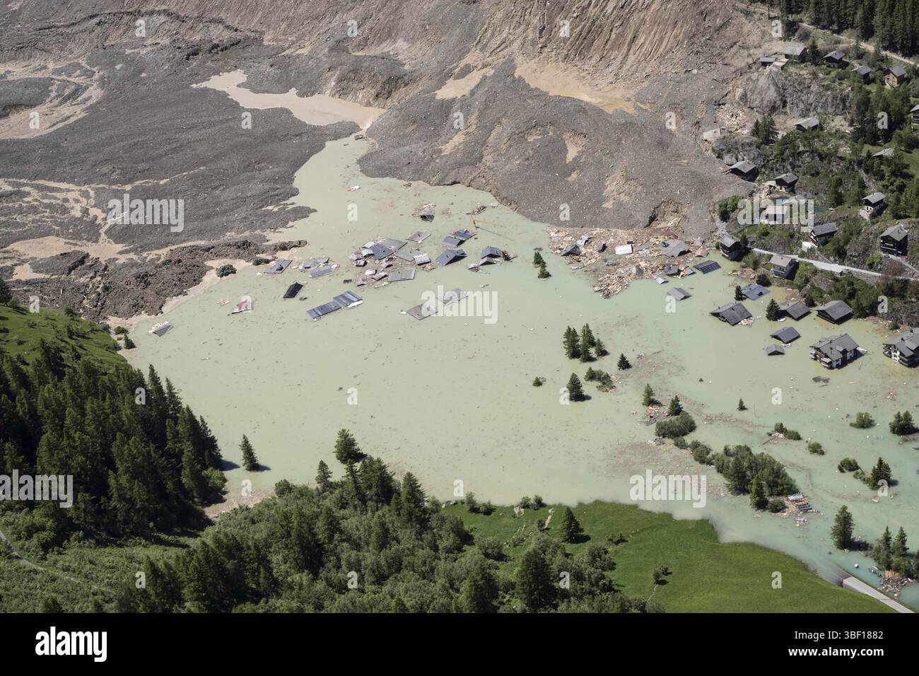 Water from the Lonza river flows over the mud and stone, after the ...
