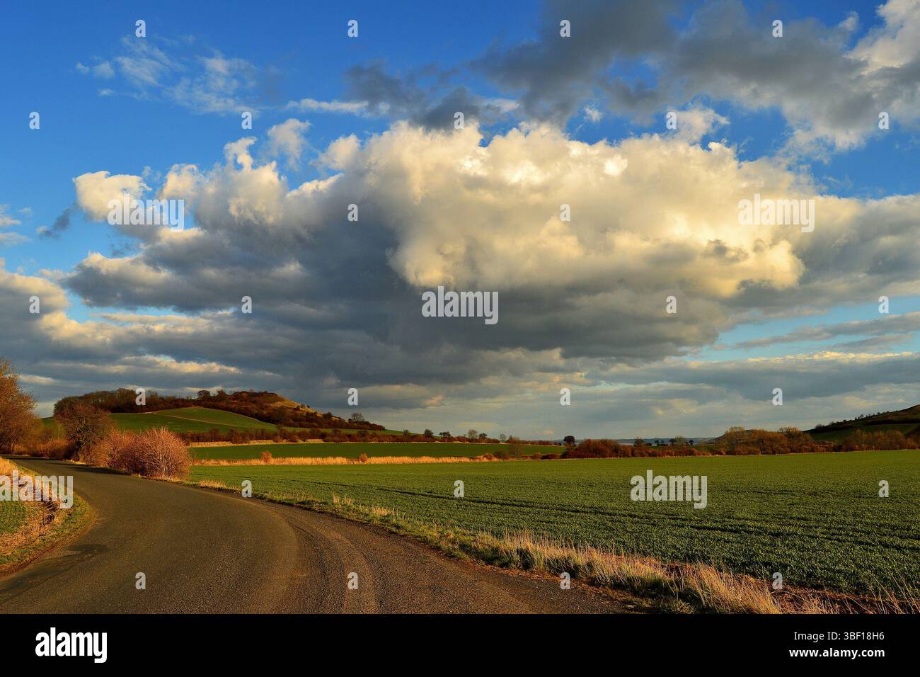 Rolling Hills and Country Road Under Ever-Shifting Cloudy Stormy ...