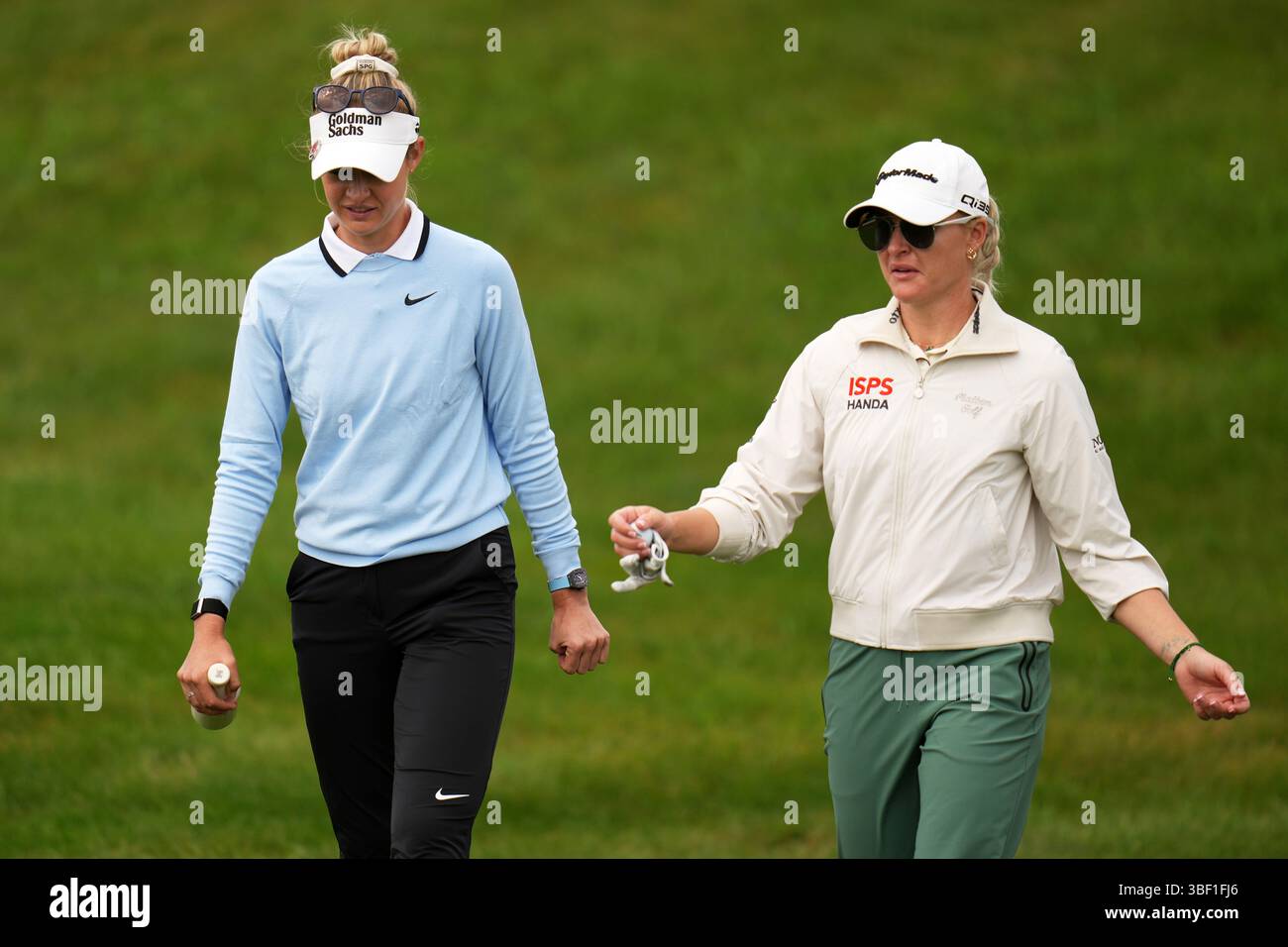 Nelly Korda talks to Charley Hull, of England, on the way to the 18th ...