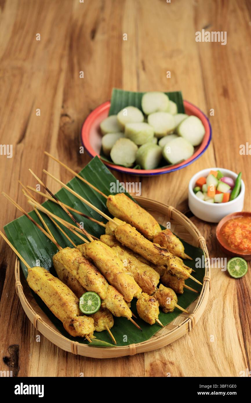 Sate Ayam Bumbu Kuning or Chicken Satay with Turmeric Spice, Served with Lontong and Kerupuk ...