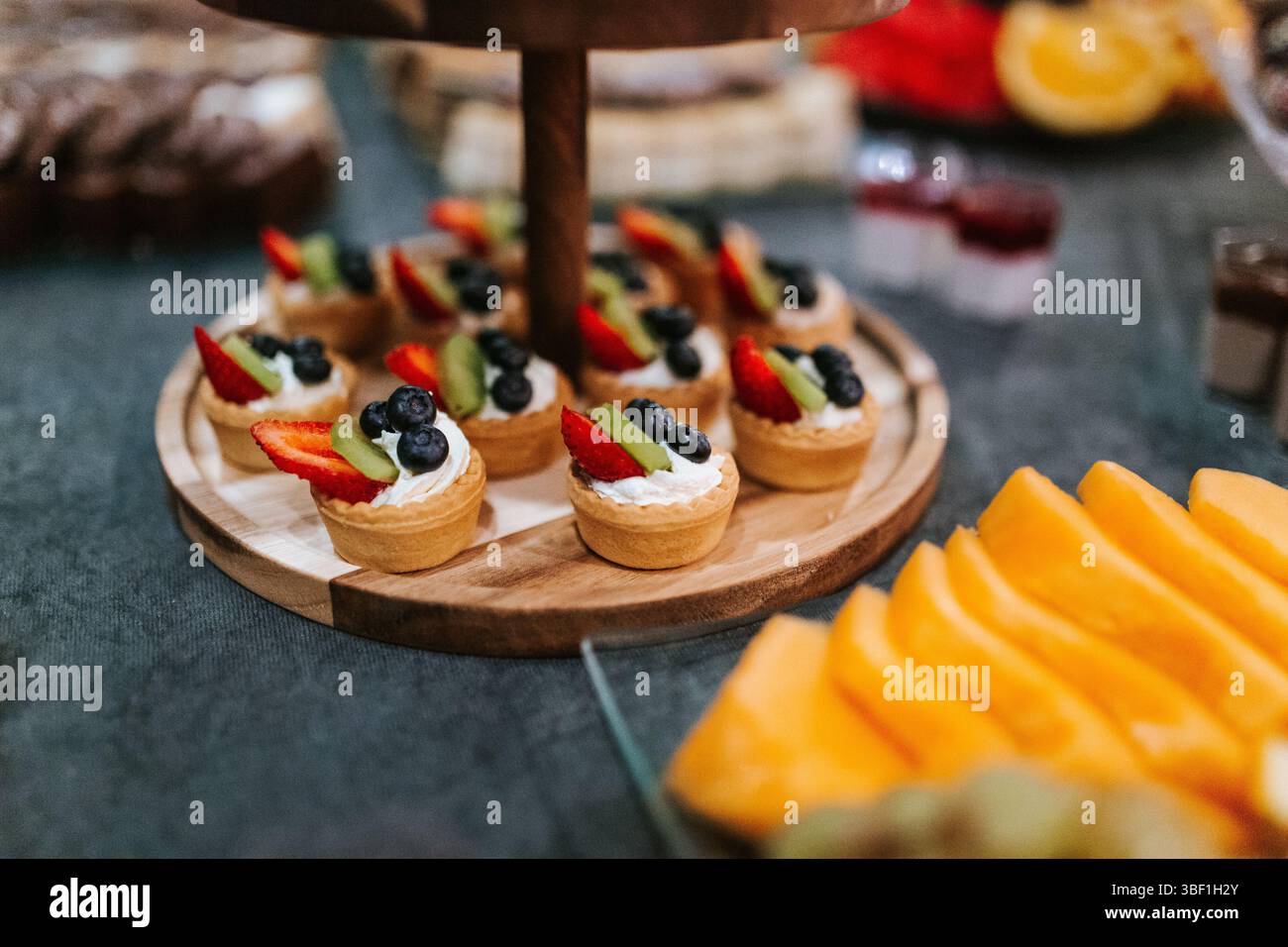 A close-up photo of a platter filled with miniature tarts. The tarts ...