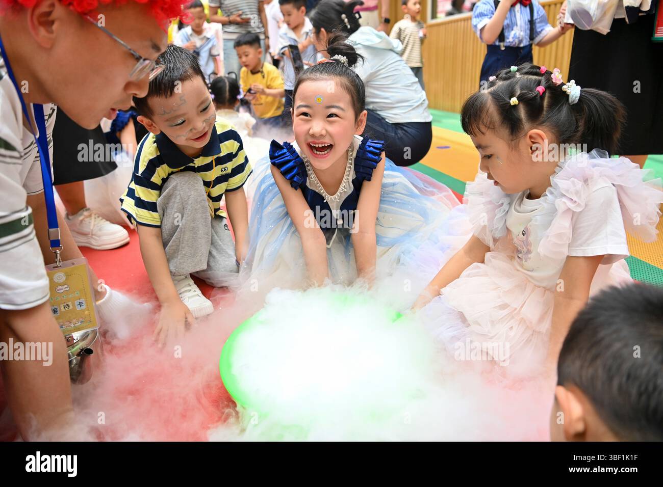 Beijing, China. 30th May, 2025. Children watch a dry ice experiment ...