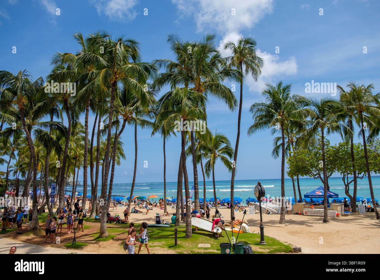 Tourists enjoy Waikiki Beach, Oahu, Hawaii. People are swimming ...