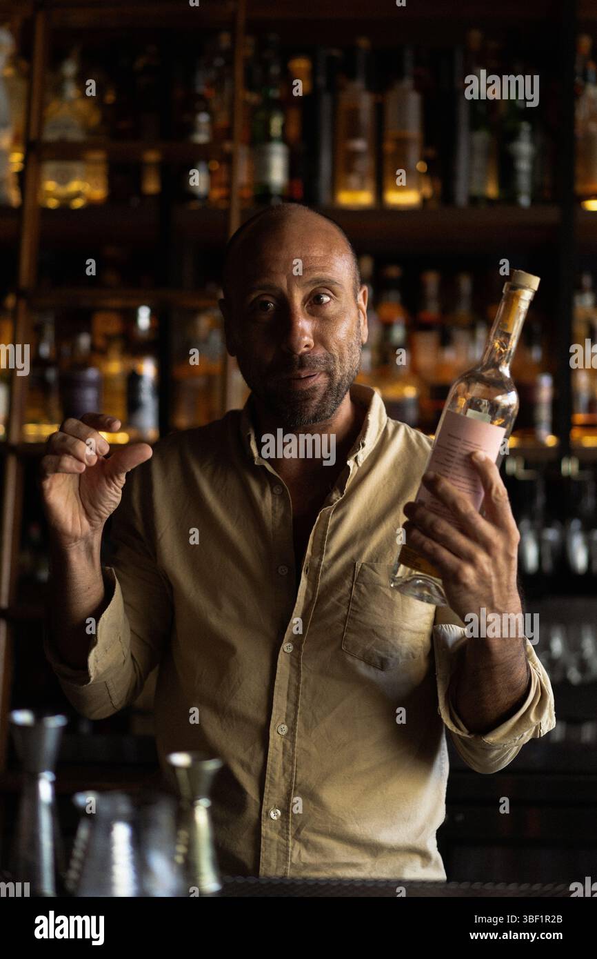 Mexican man talks about mezcal and tequila in a bar, master class Stock ...