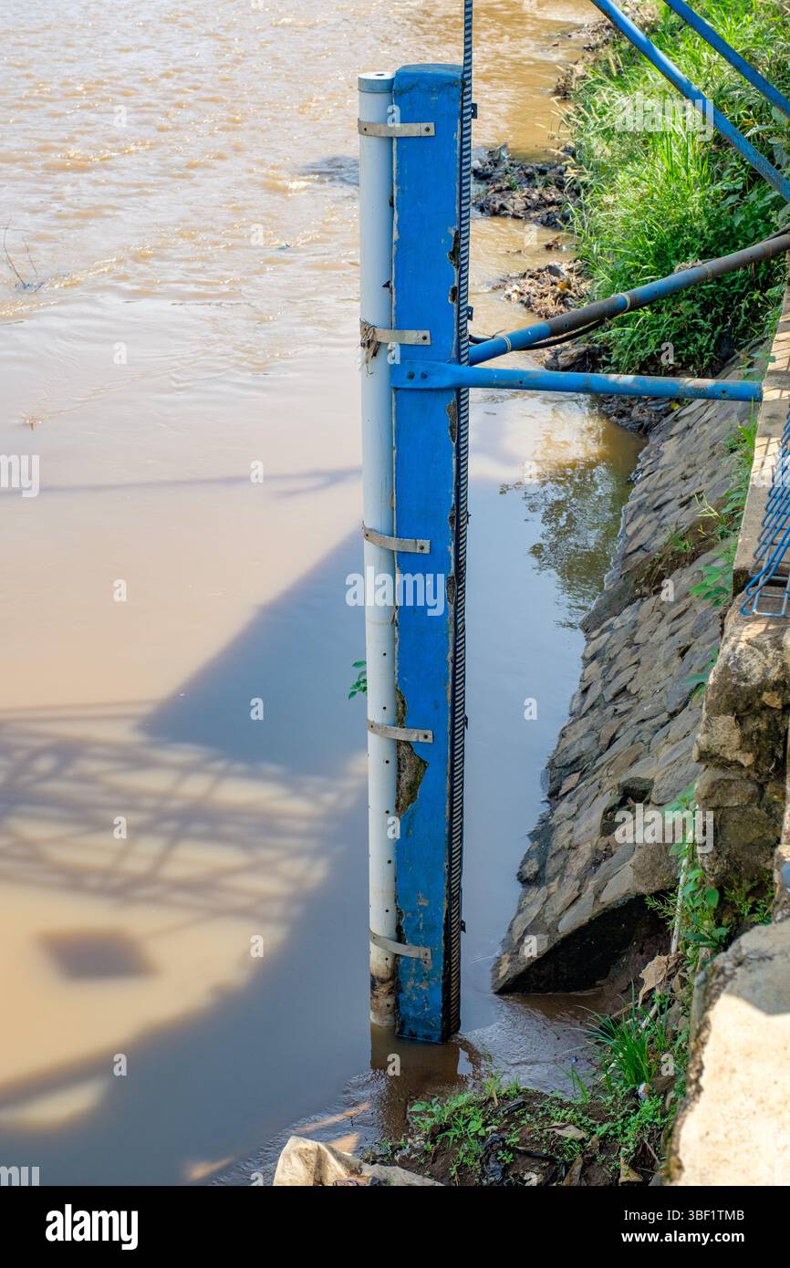A water level gauge measures the river's depth, aiding in flood ...