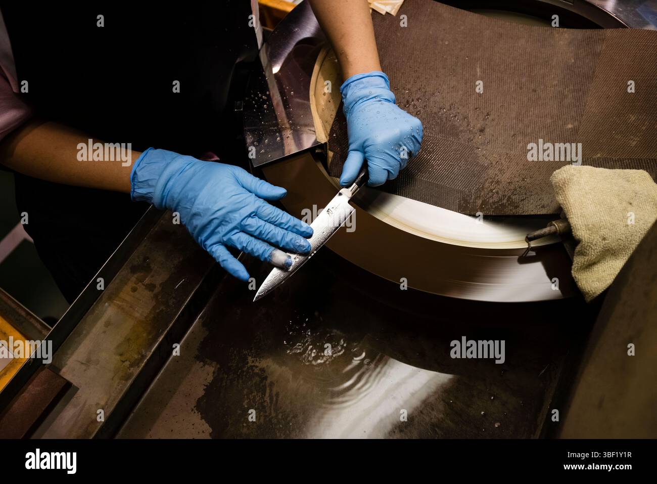 Hands sharpen knife blade at Kai Corporation, Gujo, Japan Stock Photo ...