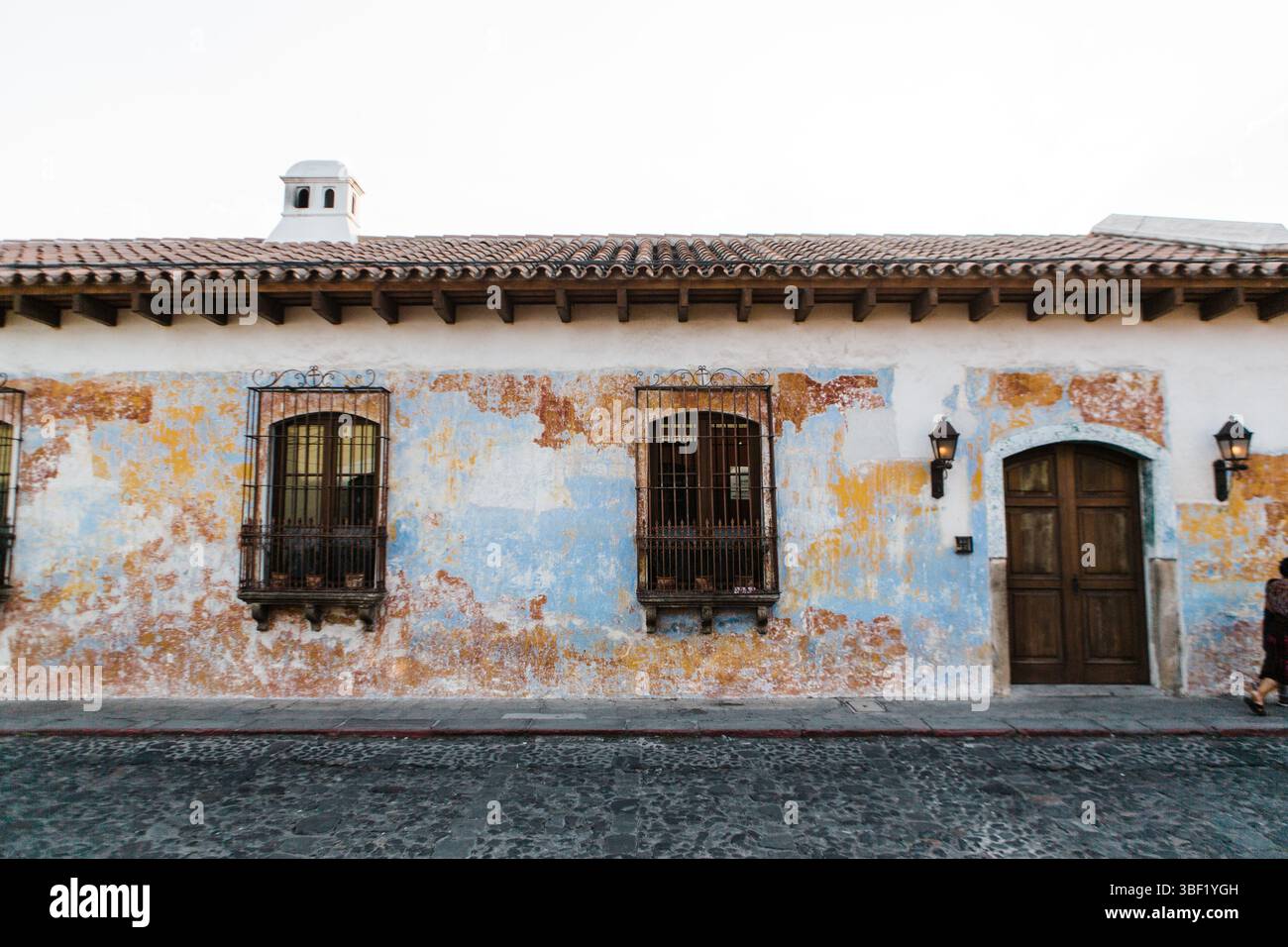 Weathered colonial colorful wall with iron windows in Antigua Stock ...