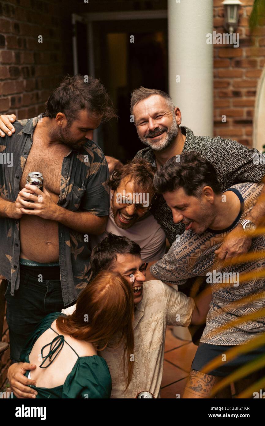 Group of friends laughing and sharing a joyful moment at a party Stock ...